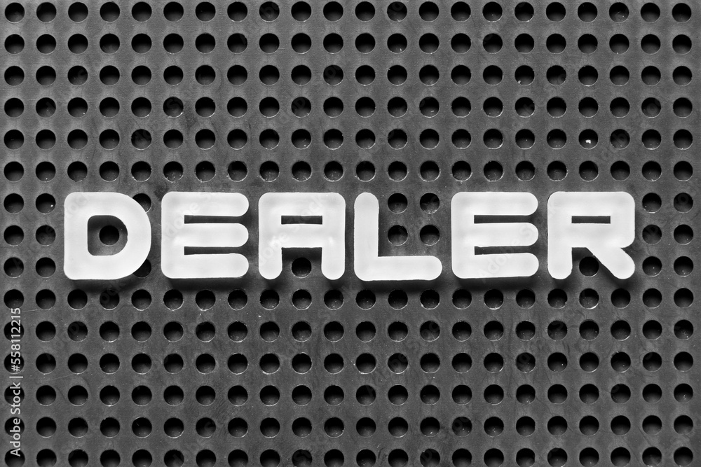 White alphabet letter in word dealer on black pegboard background Stock ...