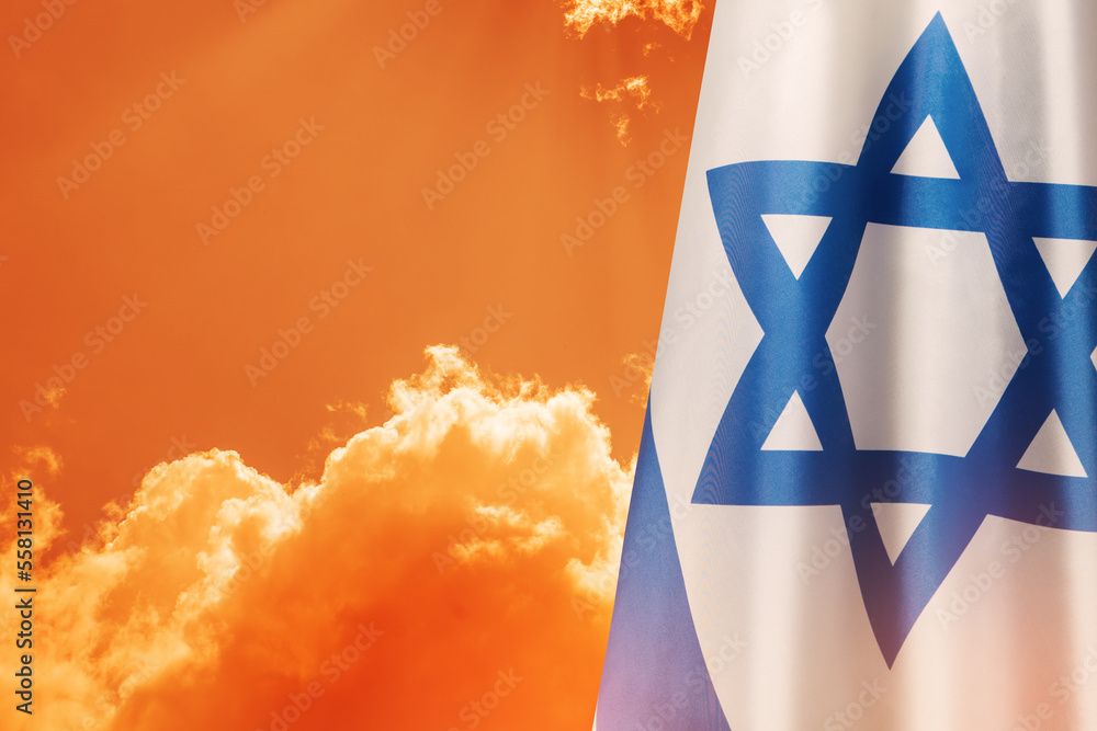 Israel flag with a star of David over cloudy sky background on sunset ...