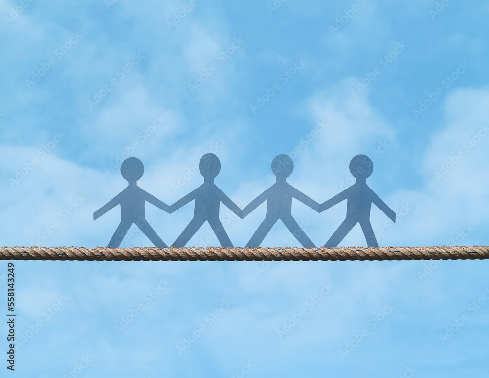 Teamwork mission support. Paper doll walk on the tight rope stretched ...