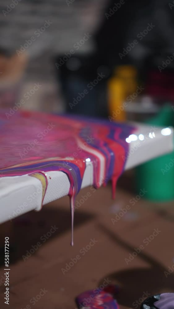 Paint drips from the canvas and drips onto the table. Creative process ...