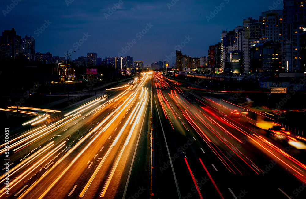 Rush hour traffic shot from above over a busy road showing streaking trails of light of blurred ...