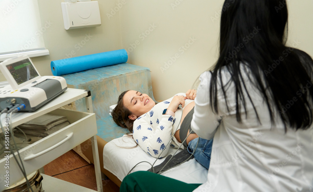 Happy pregnant female visiting her own gynecologist in medical clinic ...