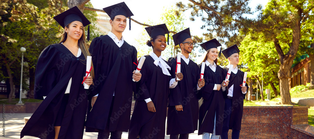 Positive multiracial graduates people men and women dressed in academic ...