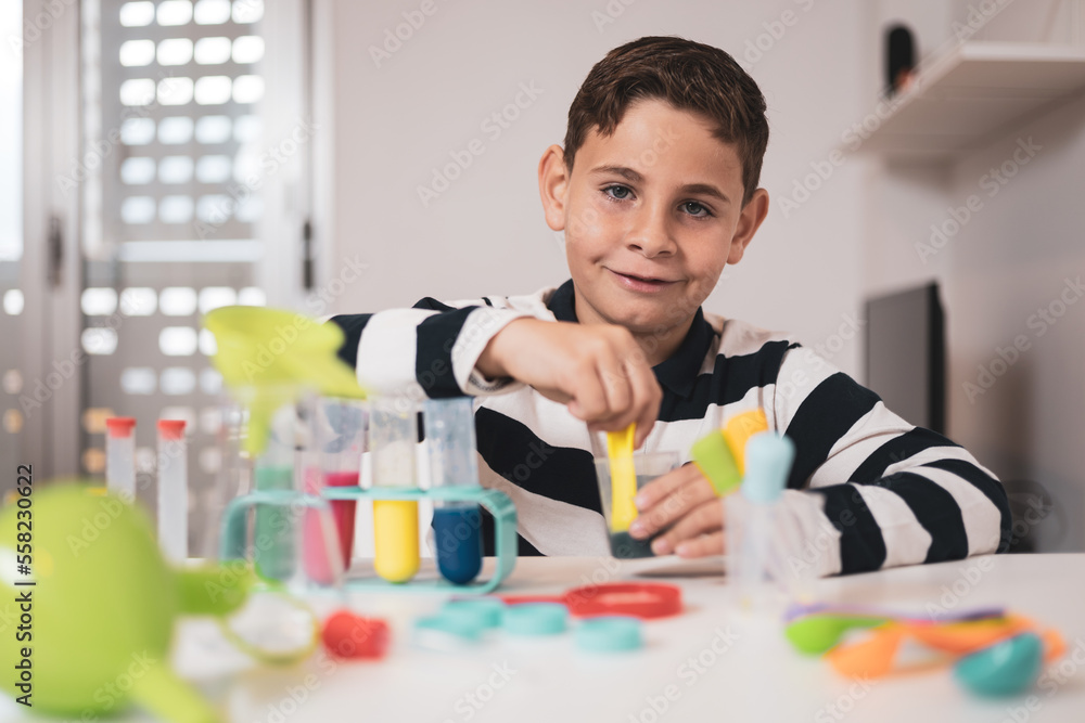 Boy having fun with chemistry lab in his living room. Science ...