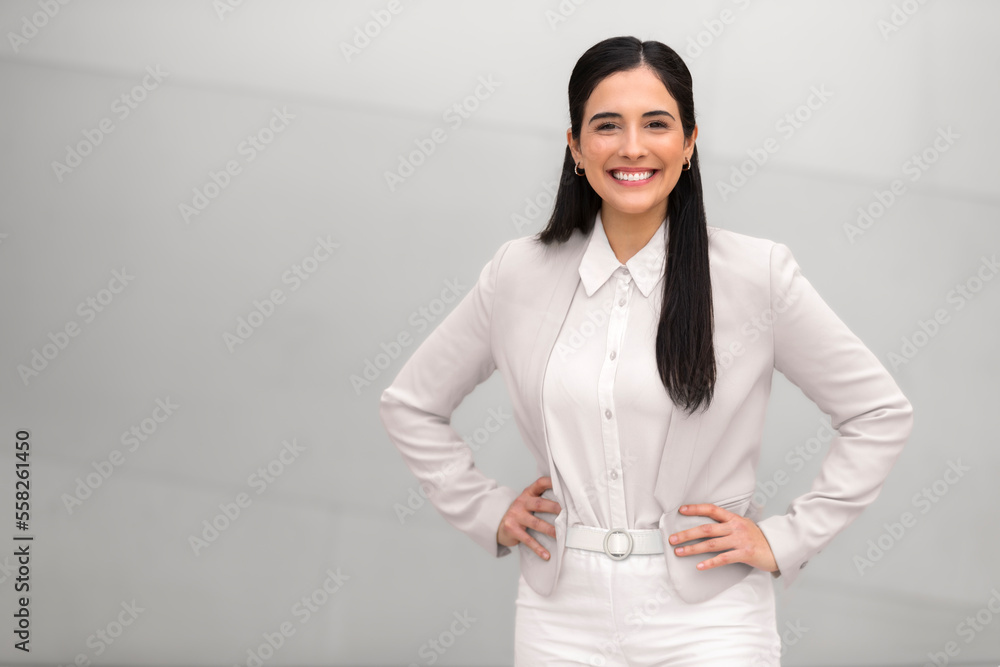 Portrait of a confident brunette business woman standing proud in suit ...