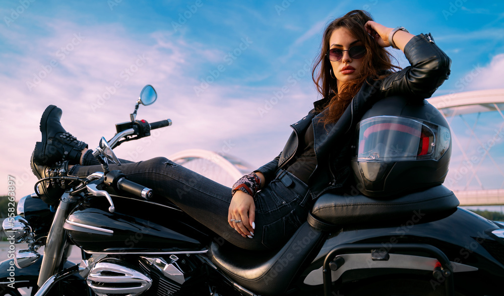 Amazing attractive confident woman laying on top of the motorcycle ...