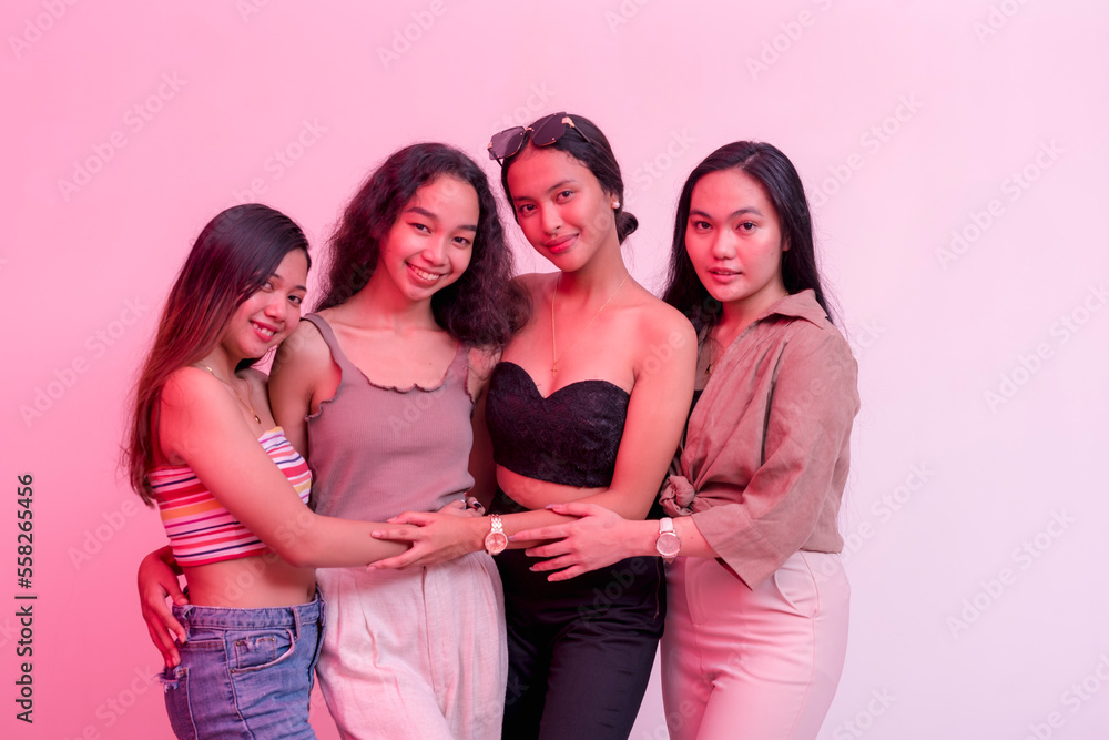Four young vibrant asian ladies together having fun and smiling. Tinted ...