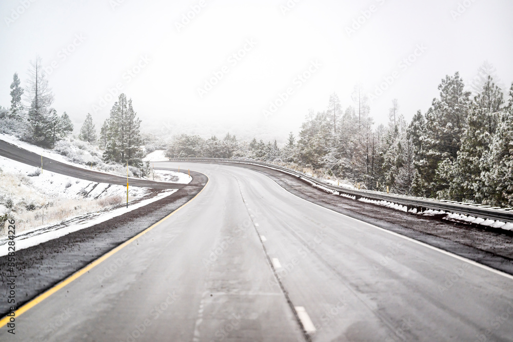 Snow-covered winter mountain winding road with snow white slopes ...