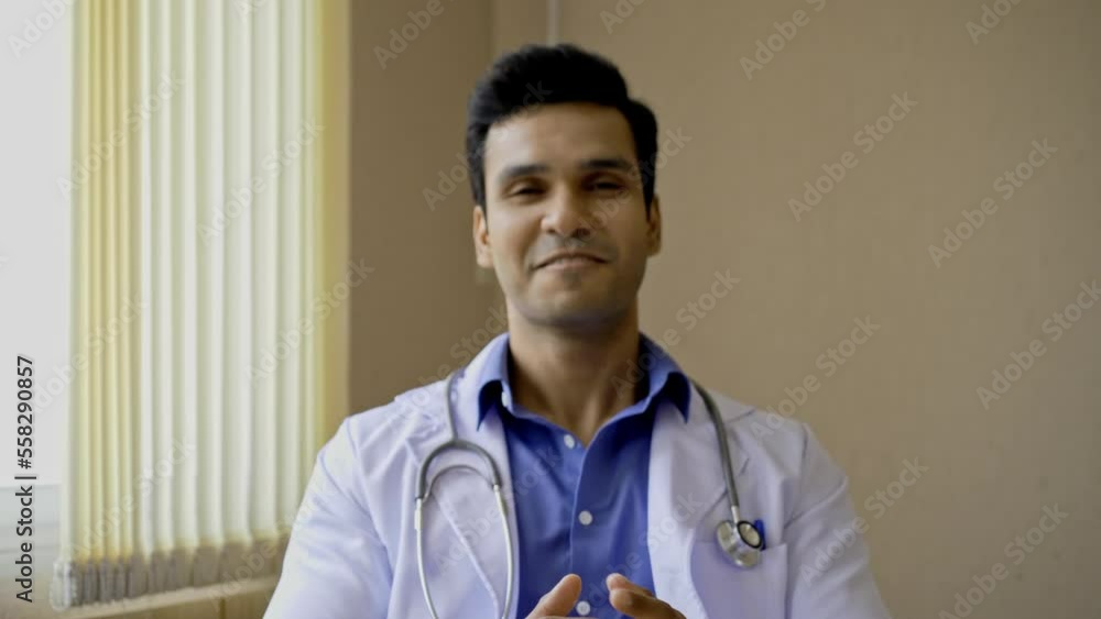 An Indian doctor is giving patient advice via video conference or video ...