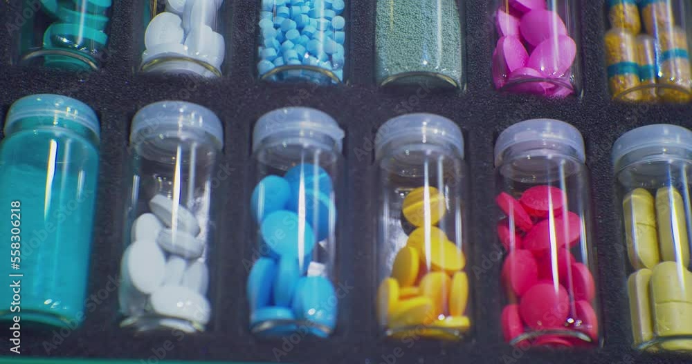 many different drugs of different shapes and colors packaged in ...