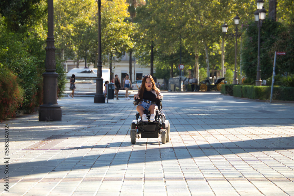 Disabled woman with reduced mobility and small stature in an electric ...