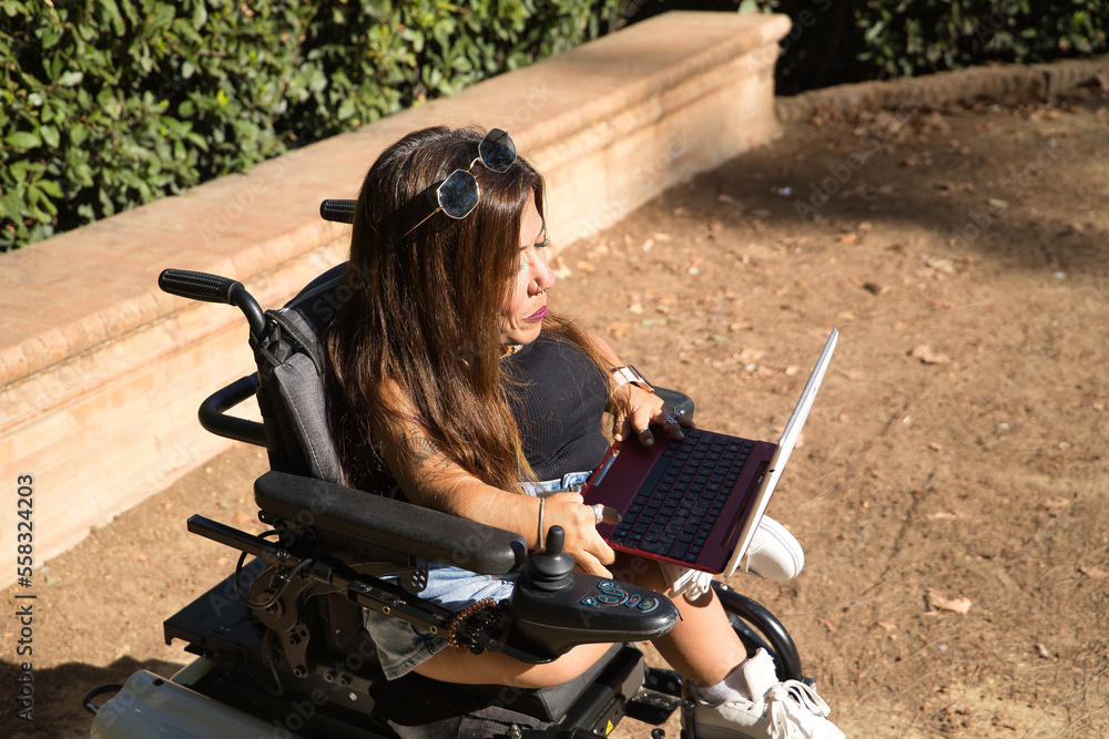 Disabled woman with reduced mobility and small stature in an electric ...