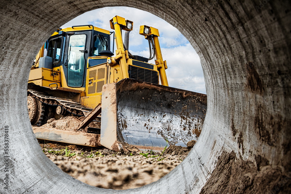 Bulldozer machine is leveling construction site. Earthmover with ...