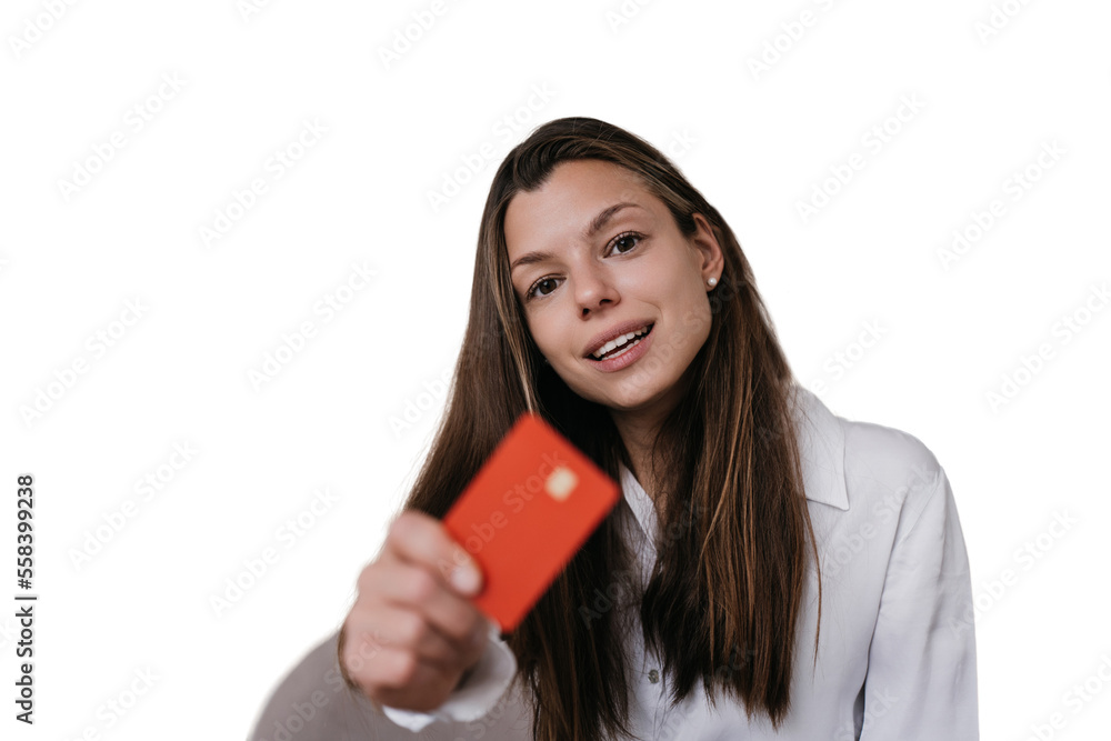 Tanned European woman with dark hair in white shirt holds credit card looks at camera over ...