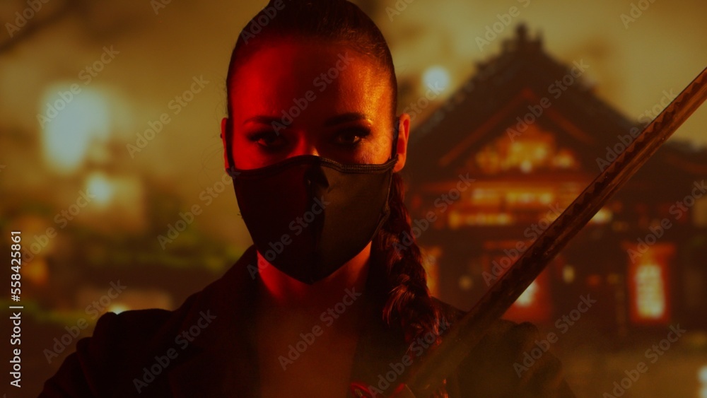 Young and beautiful ninja girl in a mask and with a katana. Samurai ...