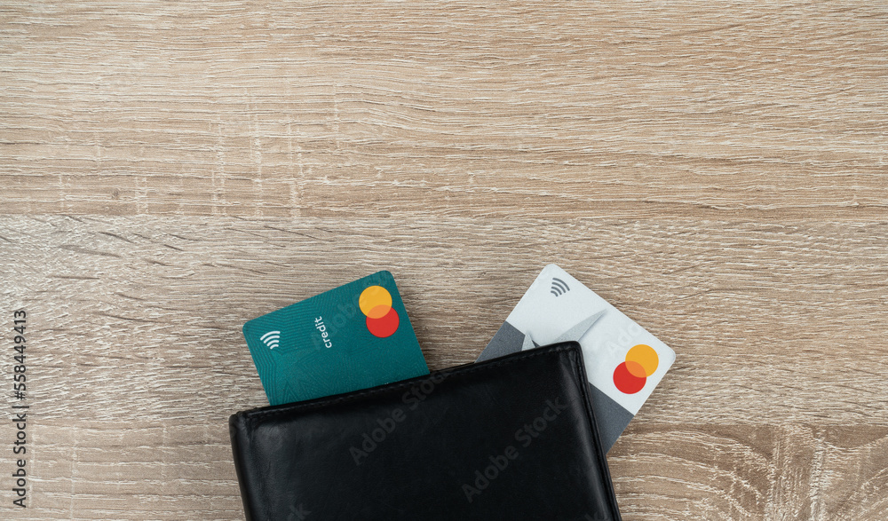 Mastercard debit and credit card in a wallet. Payment cards used for ...