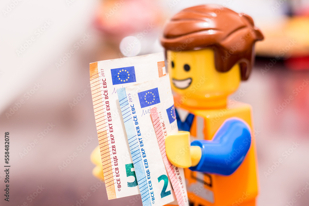 Slovakia. Sala. 01/01/2023 Euro banknotes in the hands of a LEGO worker ...
