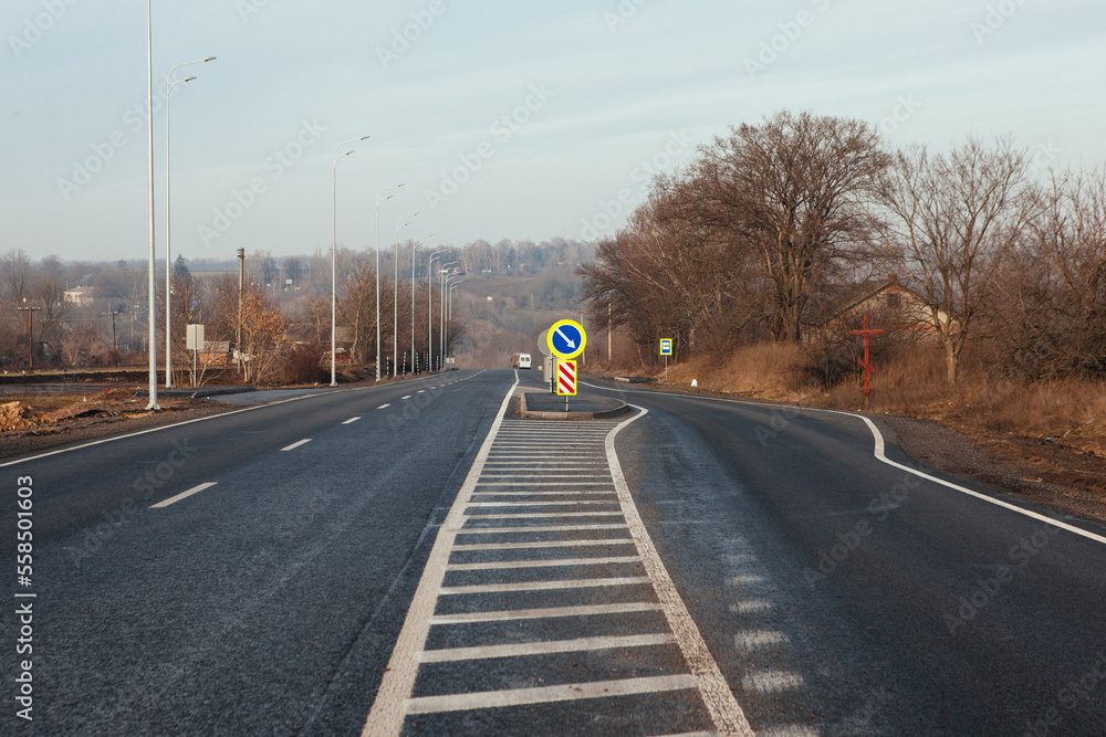 New asphalt road with markings and road signs in the sun's rays Stock ...