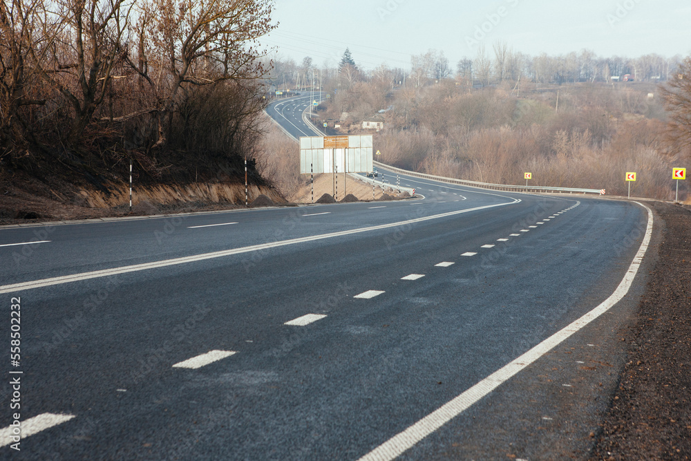 New asphalt road with markings and road signs in the sun's rays Stock ...
