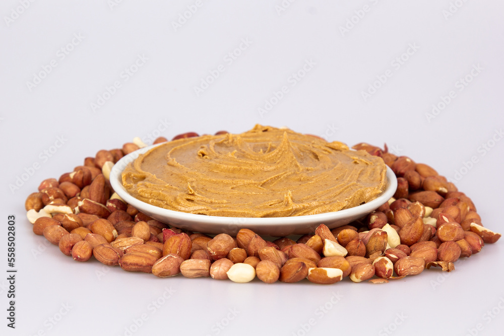 Creamy peanut butter, peanut butter in an open glass jar in the center ...