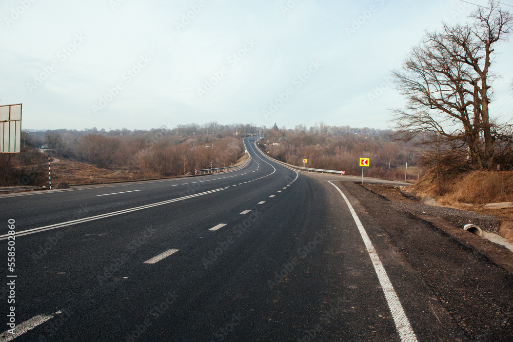 New asphalt road with markings and road signs in the sun's rays Stock ...