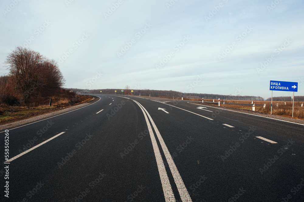New asphalt road with markings and road signs in the sun's rays Stock ...