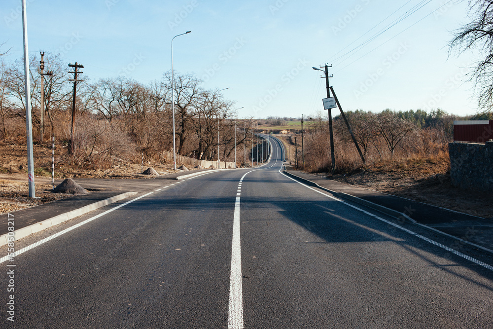 New asphalt road with markings and road signs in the sun's rays Stock ...