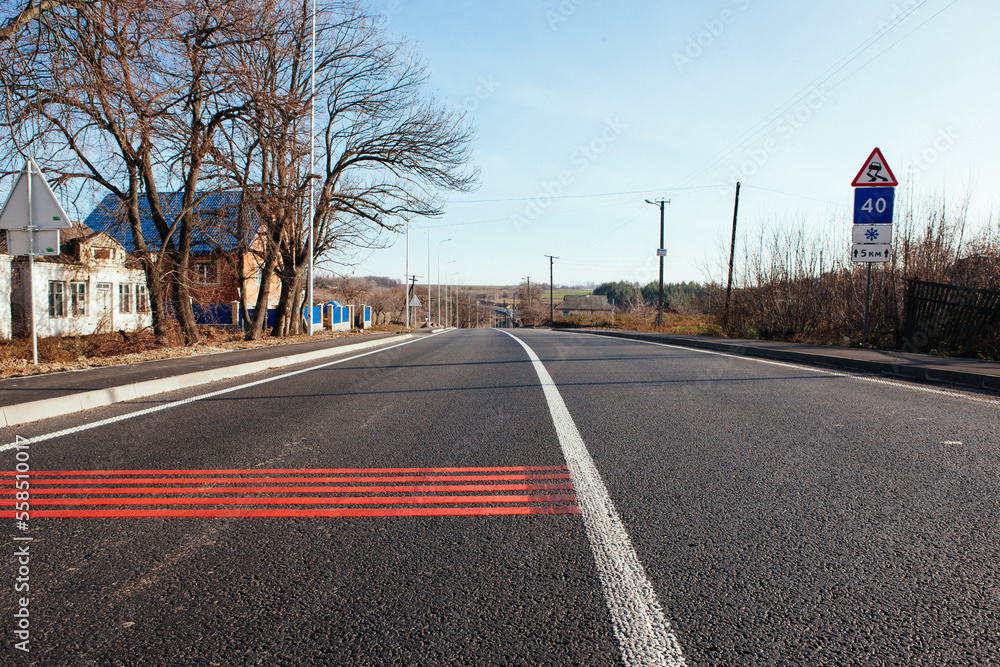 New asphalt road with markings and road signs in the sun's rays Stock ...