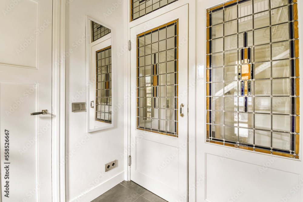 the inside of a house with white doors and glass window panes on either ...