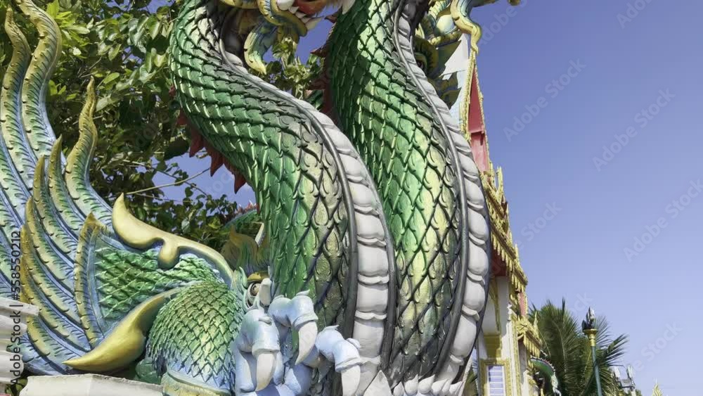 Statue of a three-headed serpent in a Buddhist temple. Wat In Plaeng is ...