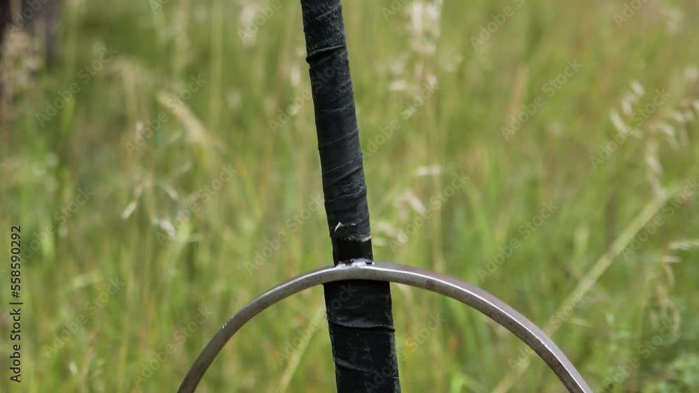 Smooth camera movement, selective focus, a two-handed sword stuck in ...