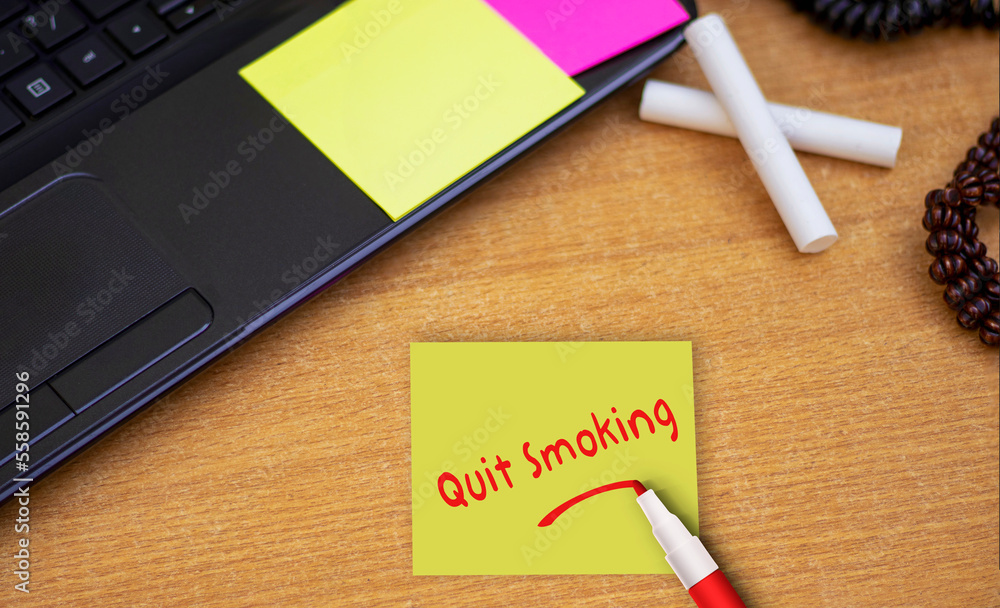 Quit Smoking sticky note pasted on the office table at the office Stock ...