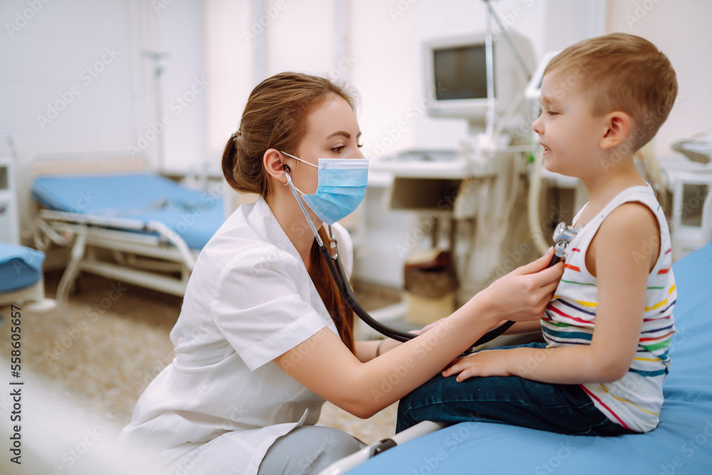 Professional general pediatrician in a white dress listen to the sound ...