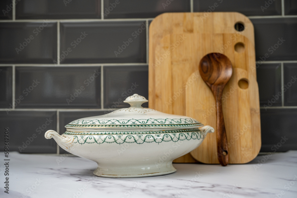 selected focus on a large antique tureen for vegetables soups food on a ...