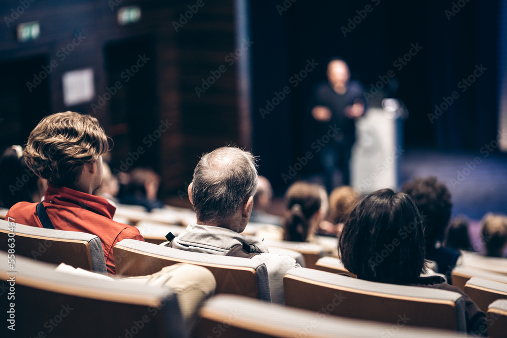 Speaker giving a talk in conference hall at business event. Rear view ...