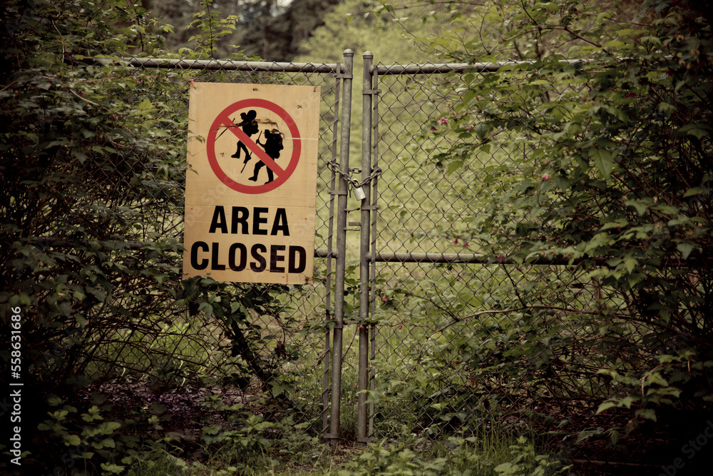 Locked gate with area closed sign. Stock Photo | Adobe Stock