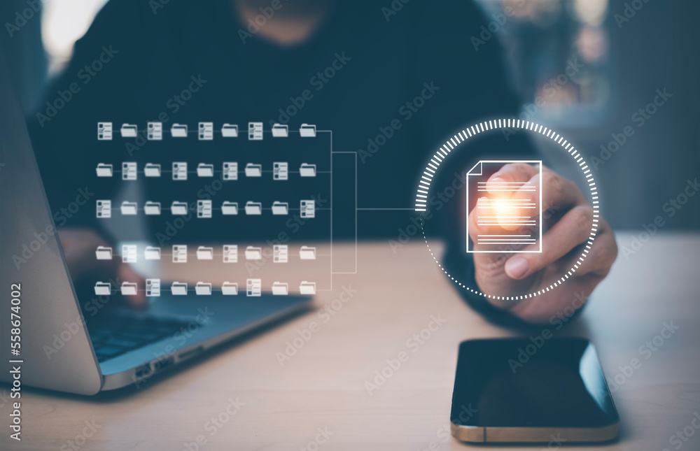 Businessman working on laptop and touch screen Online documentation database, IT consultant ...