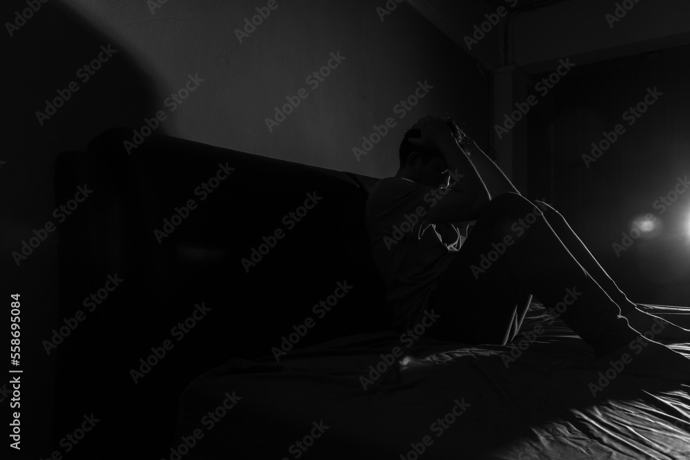 Man with depression sitting in a dark room. Depression is a low mood ...