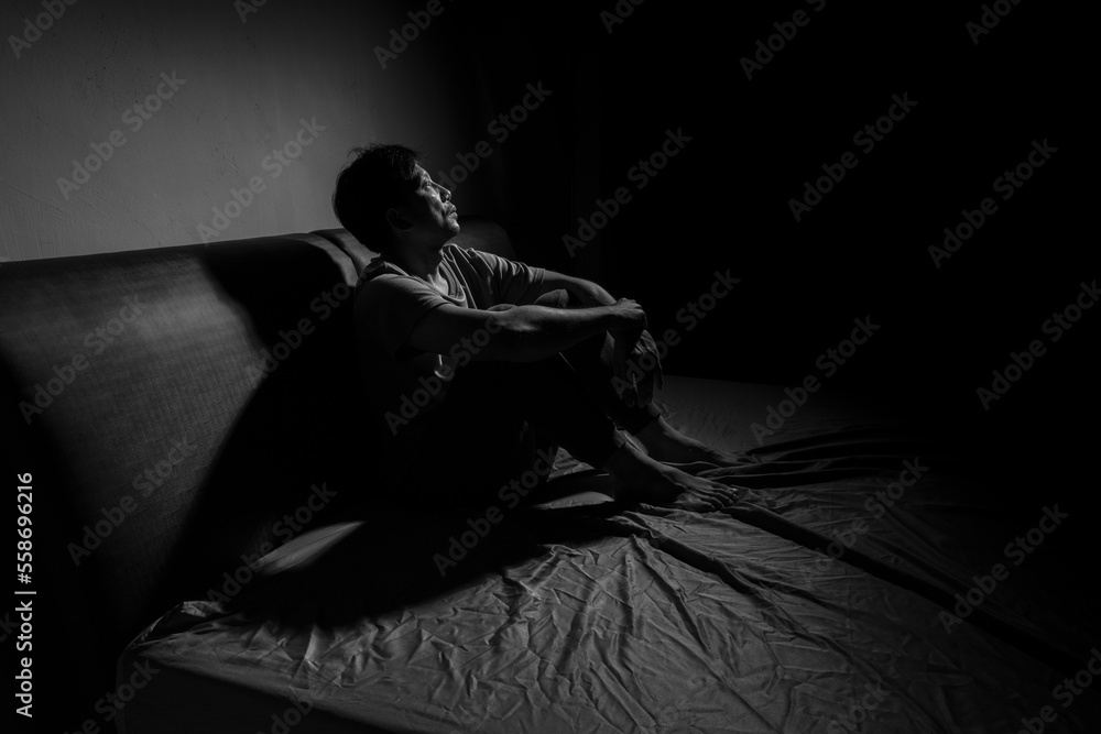 Man with depression sitting in a dark room. Depression is a low mood ...