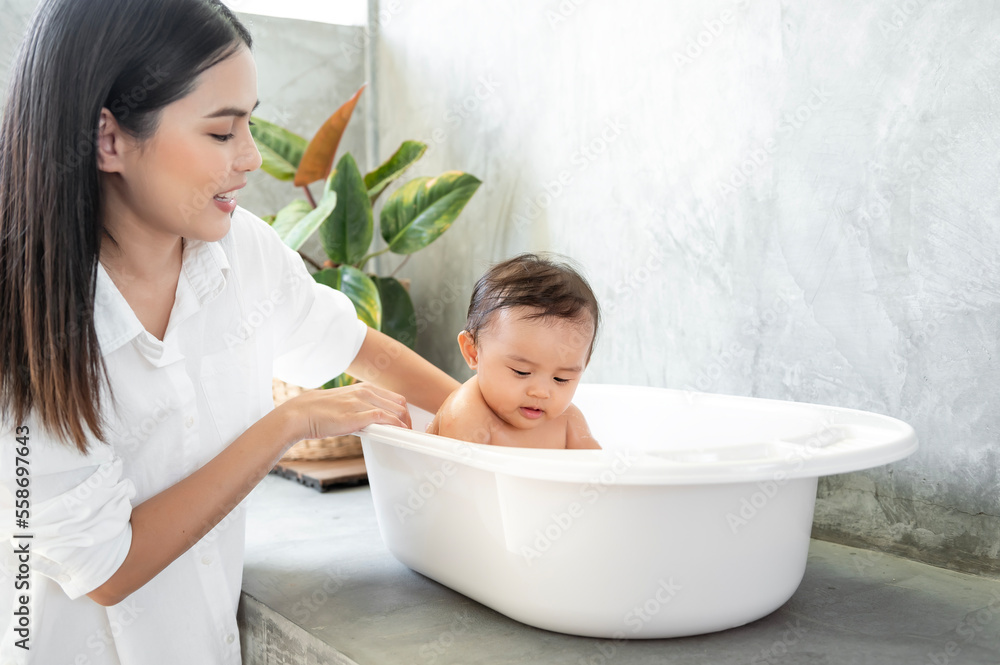 Adorable baby girl taking a bath with mother, family, child, childhood ...