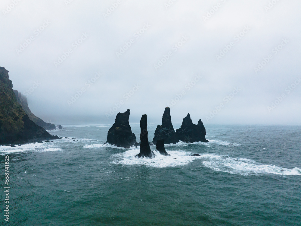 Aerial view of Reynisdrangar rocks, basalt sea stacks situated under ...