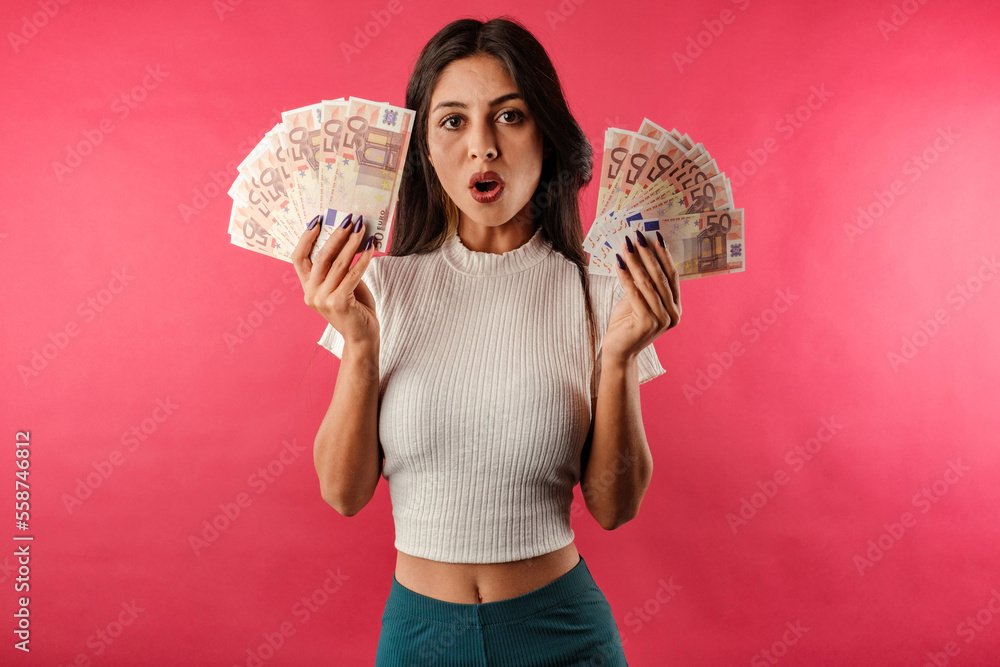 Beautiful brunette woman wearing white ribbed crop isolated over red ...