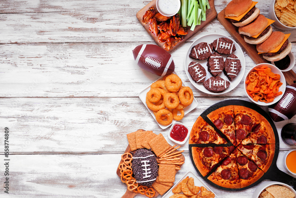 football food with pizza, burgers, wings. Overhead on white wood Stock ...