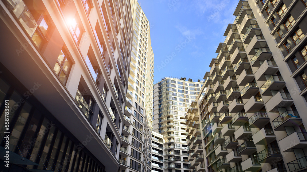 The narrow passage between modern residential buildings. Walls of high ...