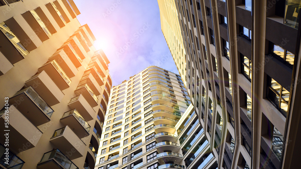 The narrow passage between modern residential buildings. Walls of high ...