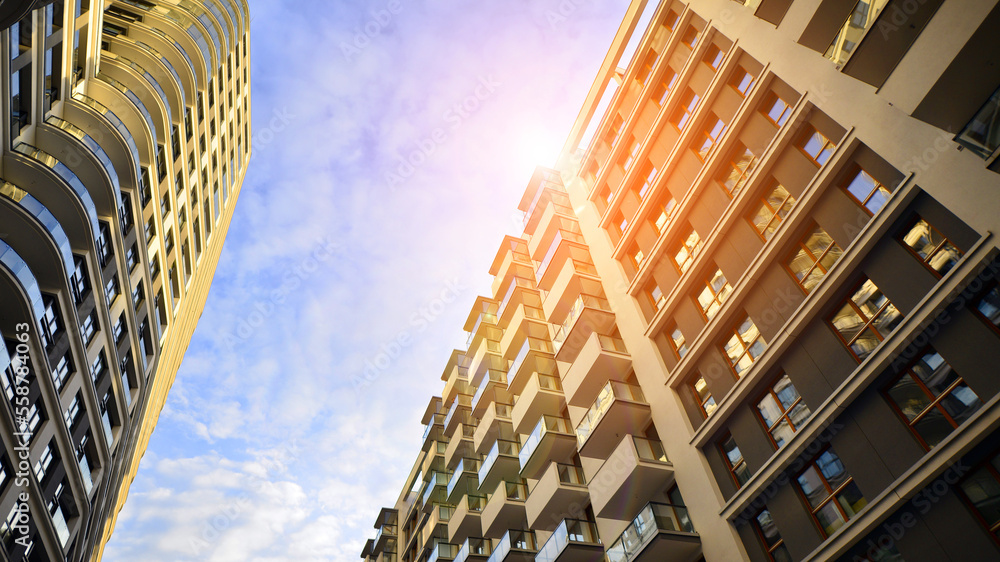 The narrow passage between modern residential buildings. Walls of high ...