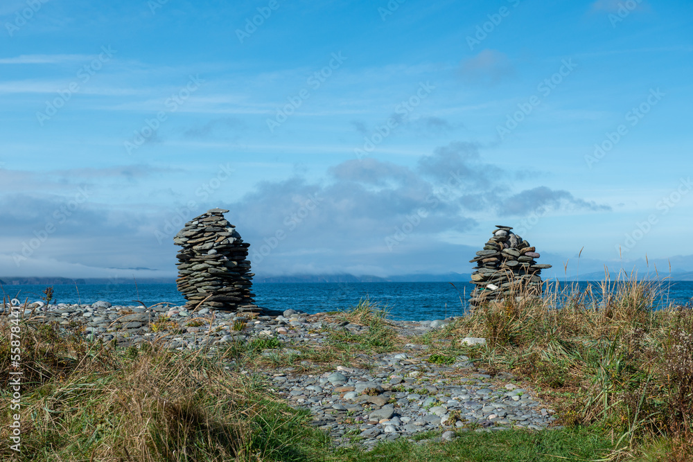 Traditional trail marker called cairns. The large mass of rocks is ...
