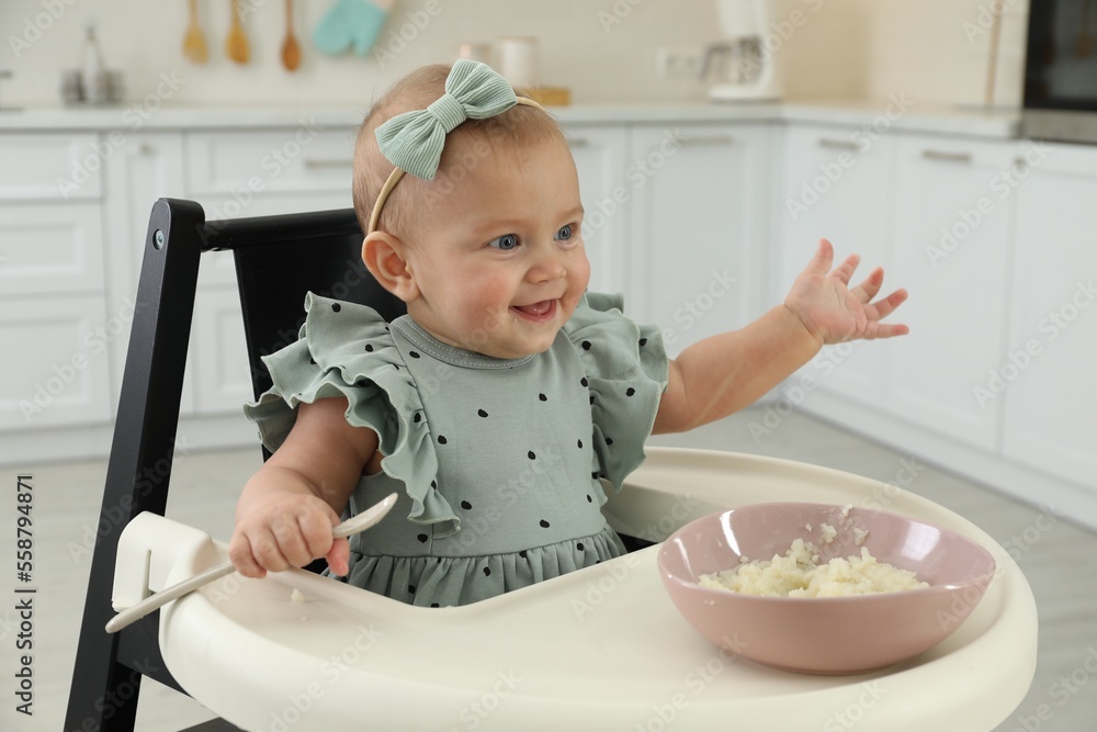 Cute little girl eating healthy food at home Stock Photo | Adobe Stock