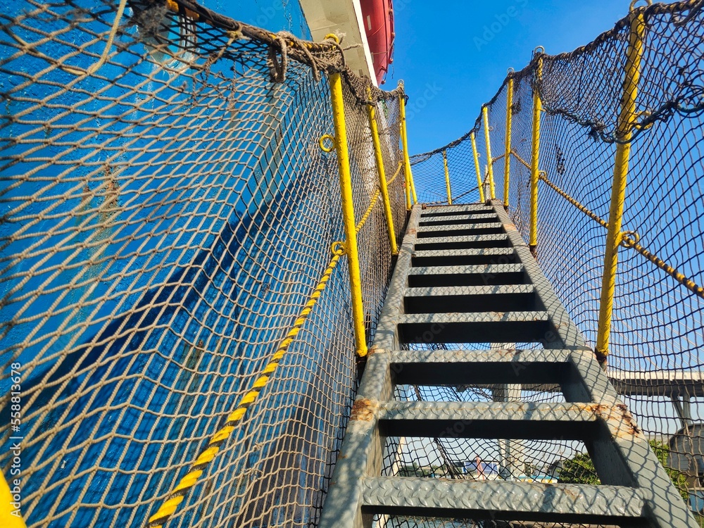 Stairway to heaven, Steep ladders, vessel gangway with nets on either ...