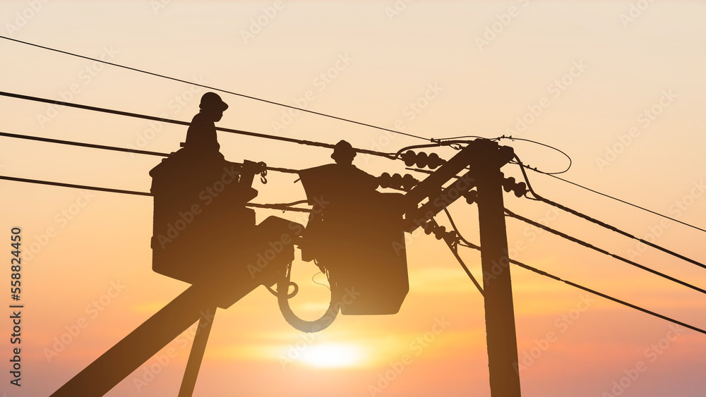Silhouette electrician work at height on crane to make electrical ...
